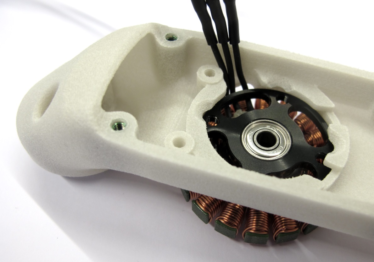 *Route the motor phase wires through the opening in the shell.
