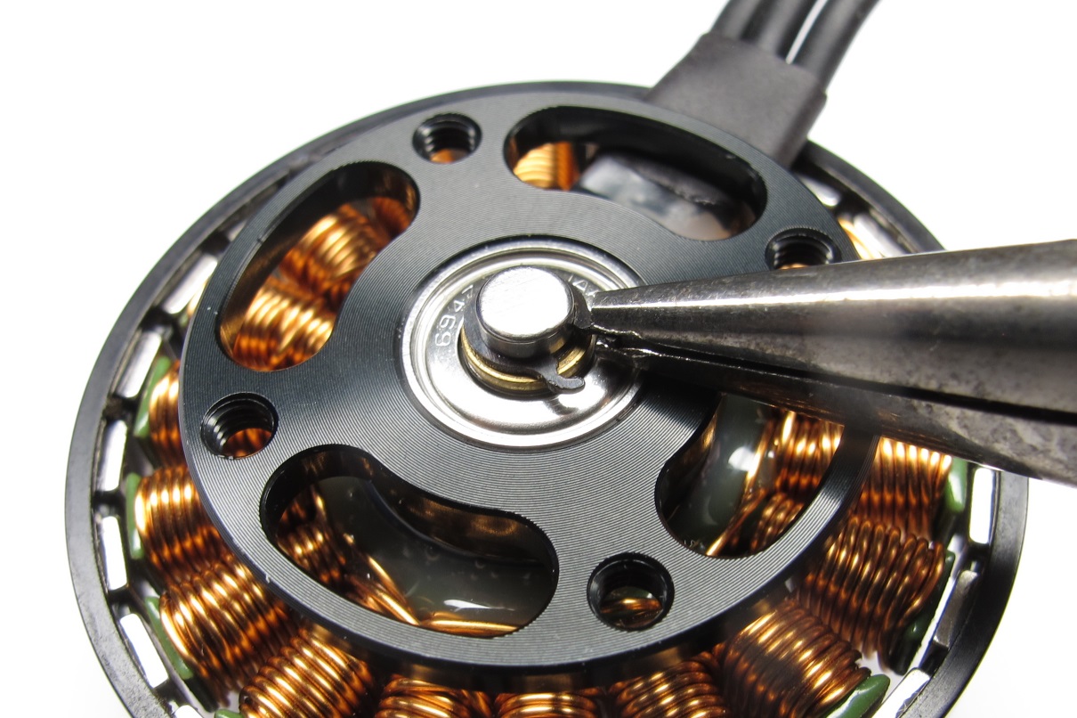 *Remove the retaining ring from the motor shaft using small pliers.